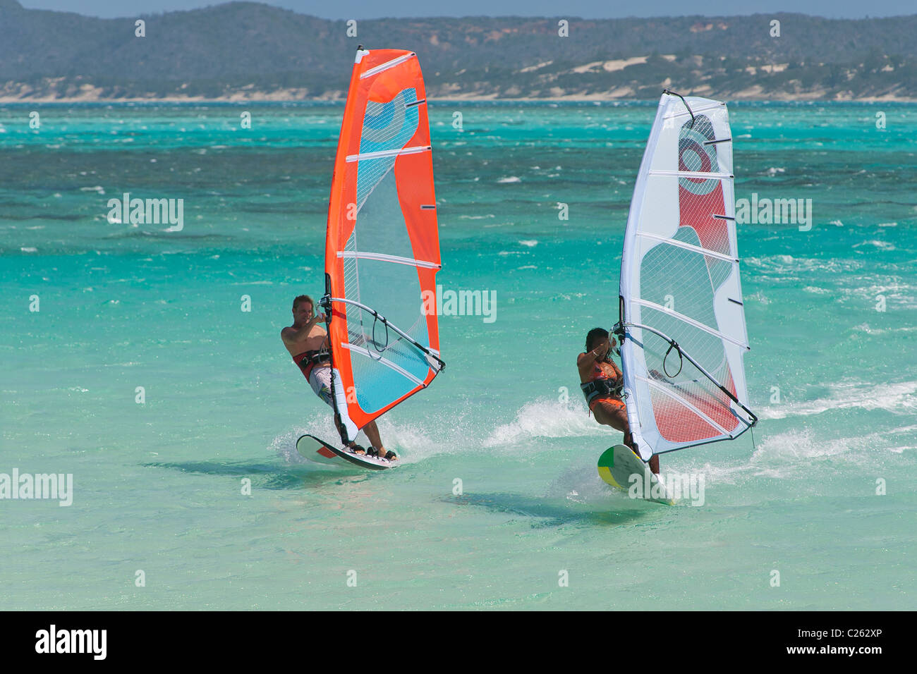 Couple man and woman windsurfing in the lagoon Stock Photo - Alamy