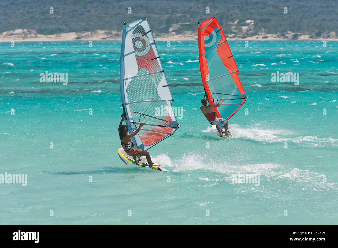 Couple man and woman windsurfing in the lagoon Stock Photo - Alamy