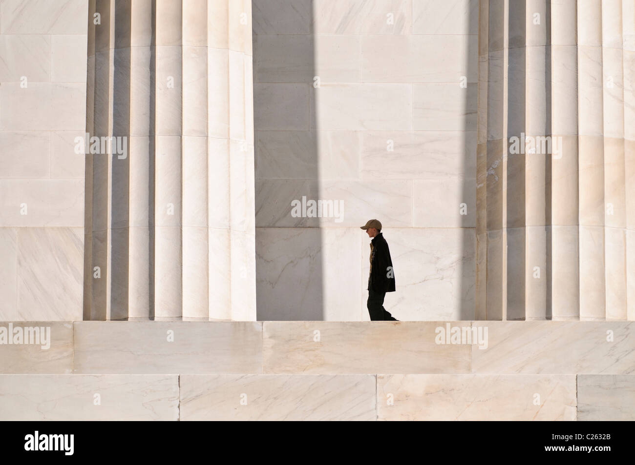 A teenage boy visiting the Lincoln Memorial is dwarfed by the massive ...