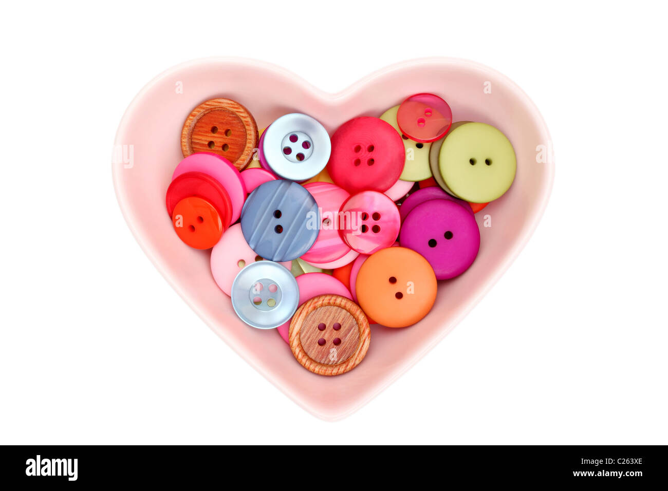 Buttons in plate of heart shape Stock Photo - Alamy