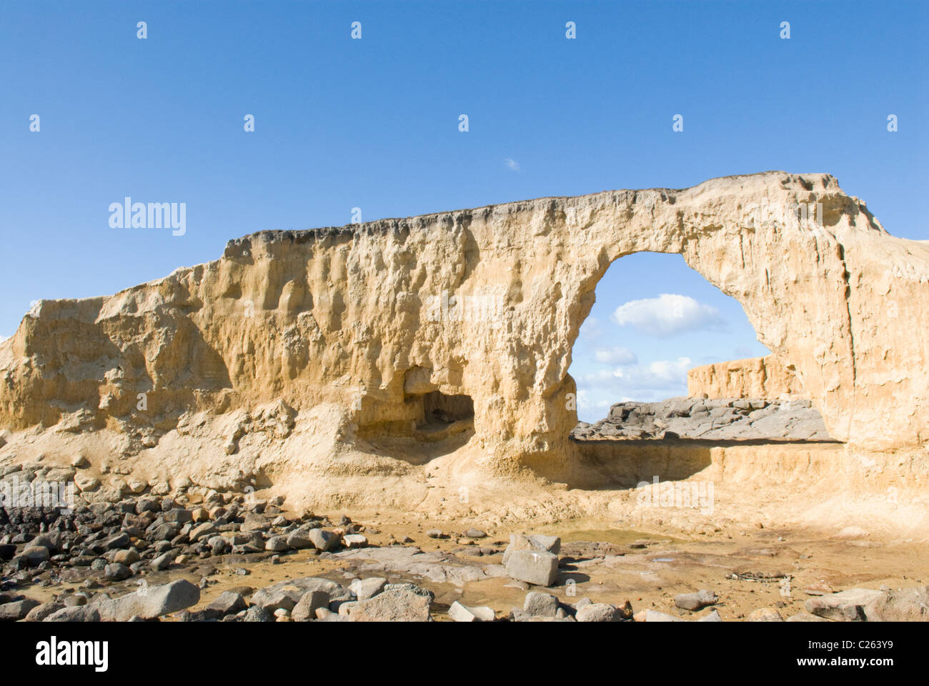 Rock arch in sea cliffs at Dashing Rocks, Timaru. Eroded loess rock ...