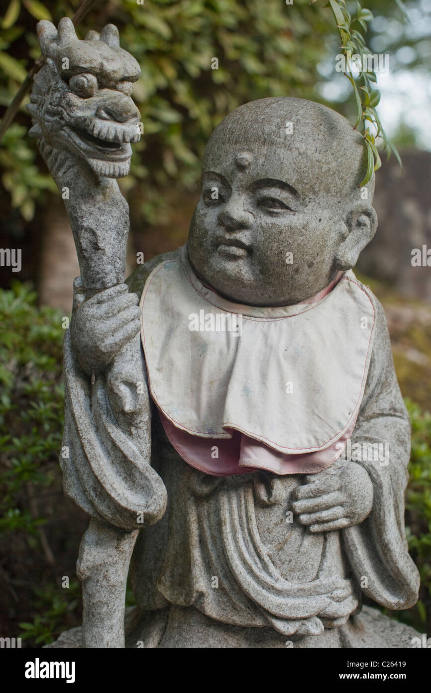 White-bibbed statue with prayer beads and dragon at Daisho-in temple ...