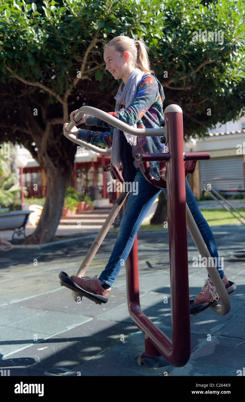 Young teenager doing exercise on a walking machine Stock Photo - Alamy