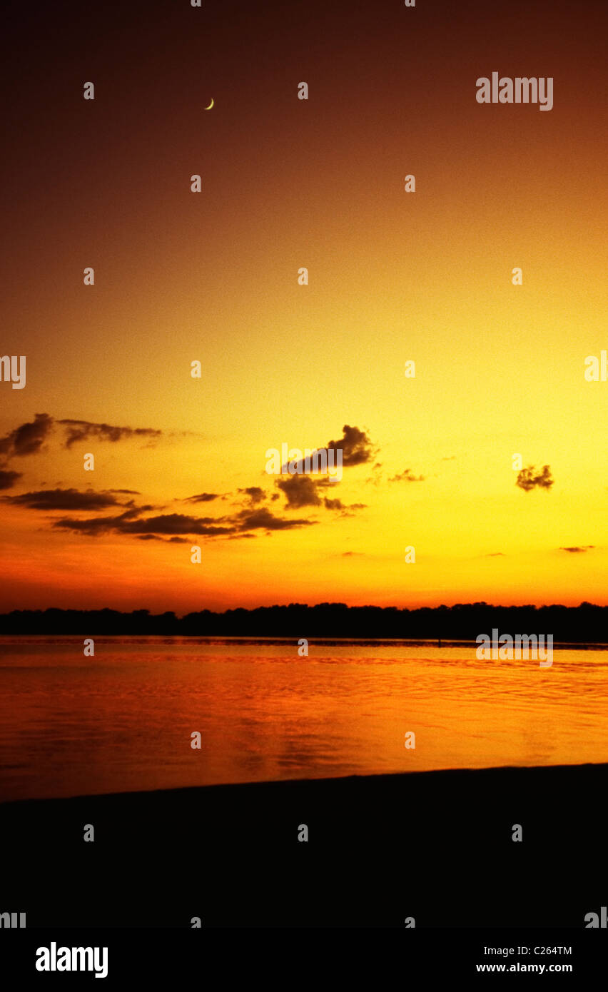 Half moon over Florida sunset Stock Photo - Alamy