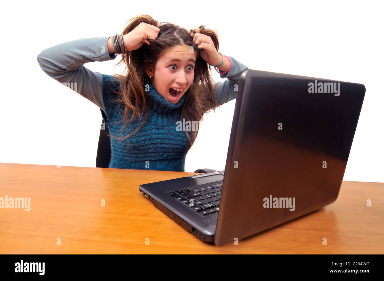 Stressed young girl in front of a laptop computer Stock Photo - Alamy