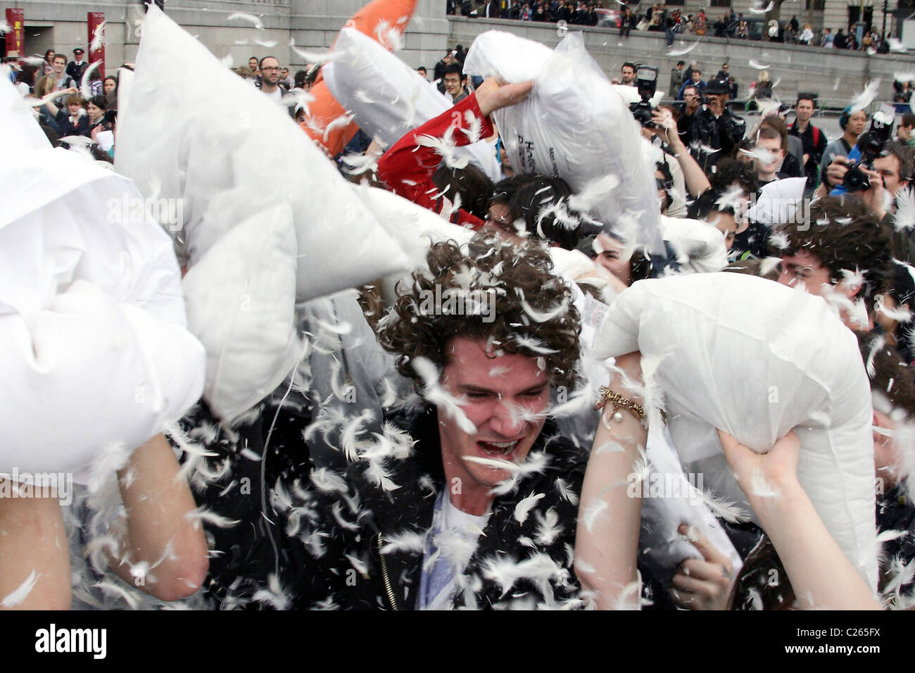 Covered in feathers during mass pillow fight Stock Photo - Alamy