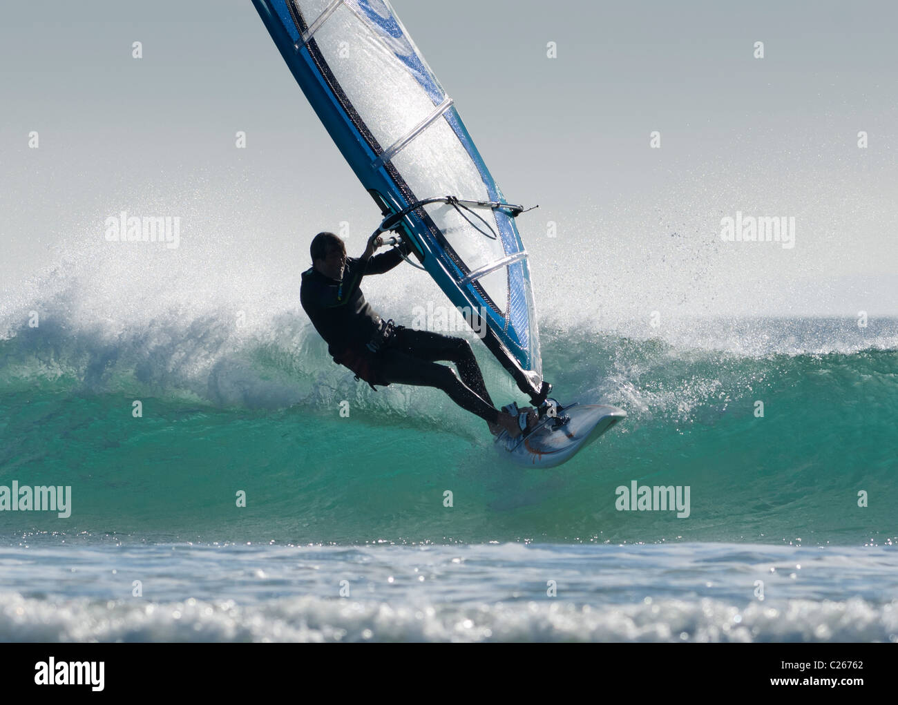 windsurfer going down a wave Stock Photo - Alamy