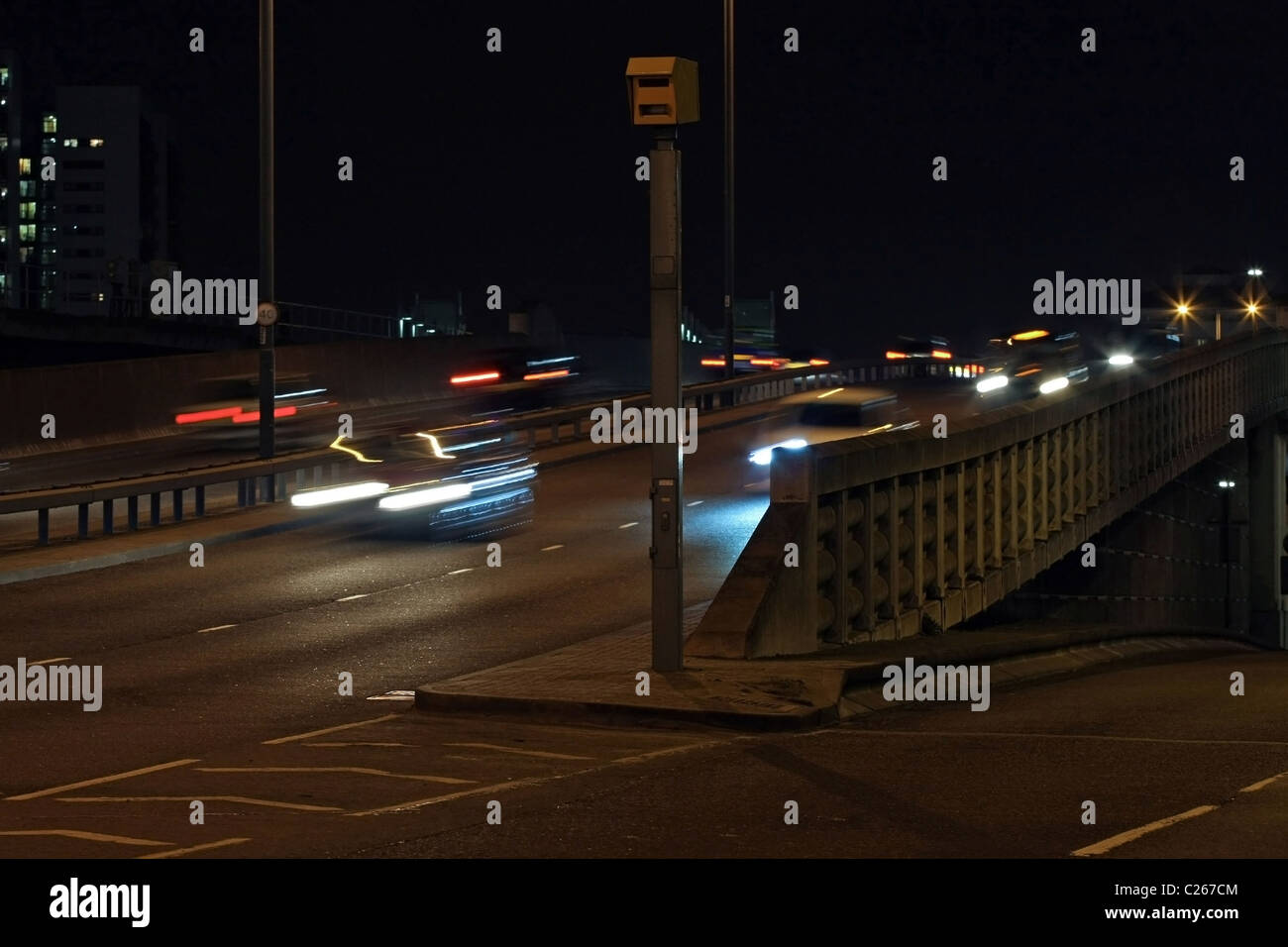 light trails of vehicles passing a GATSO or speed camera at night on ...
