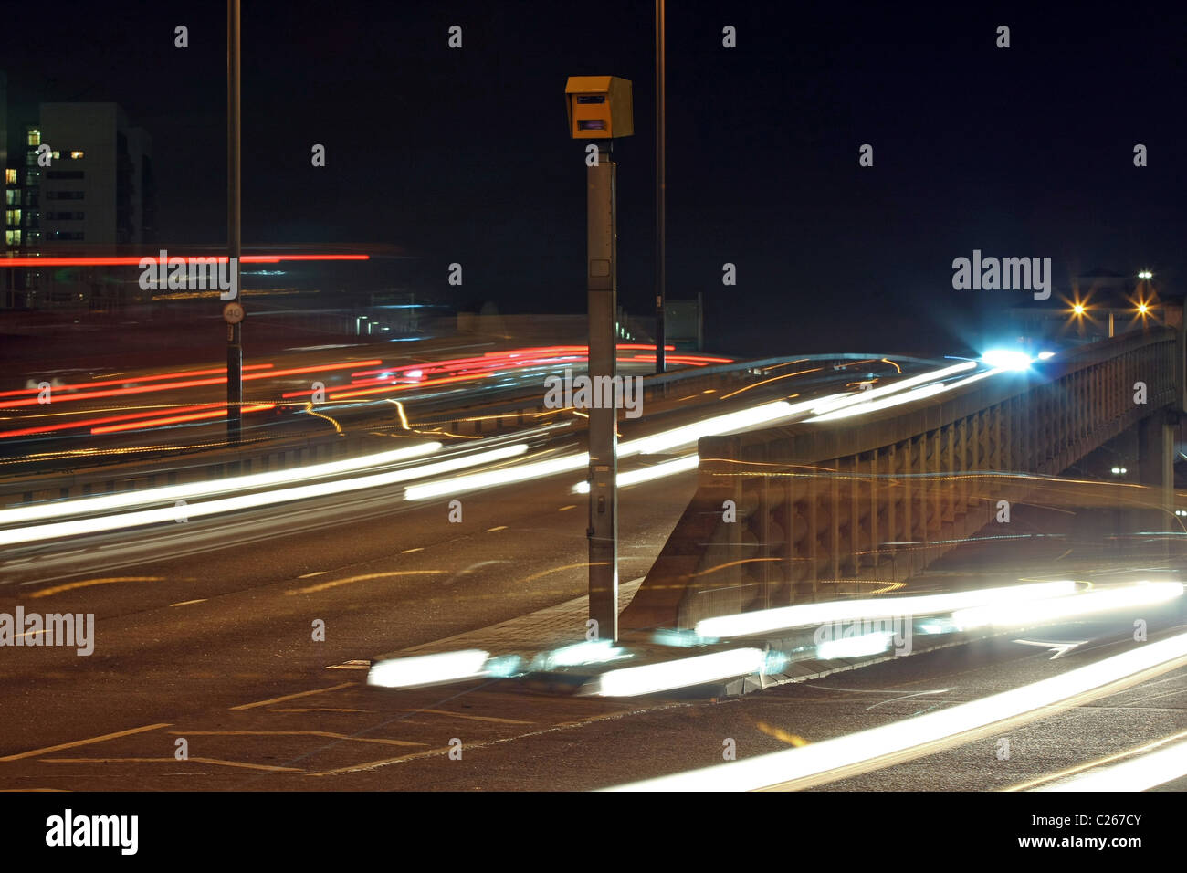 light trails of vehicles passing a GATSO or speed camera at night on ...