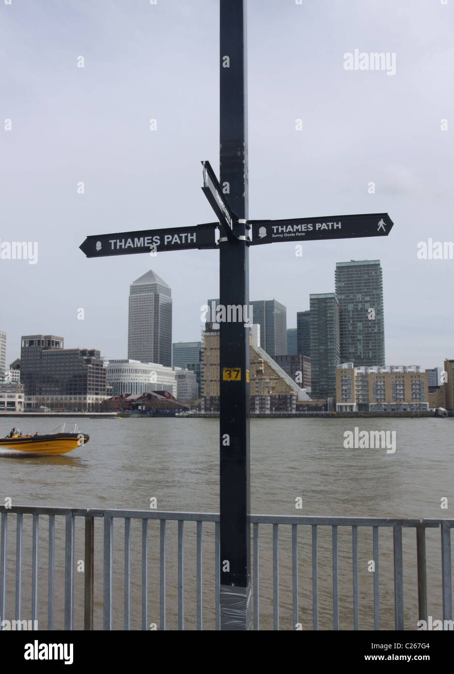 Thames Path signpost and Docklands skyline London England April 2011 ...