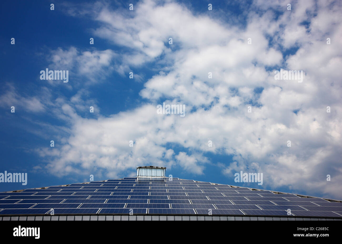 Roof of a building with solar energy panels. Blue sky, pyramid design ...