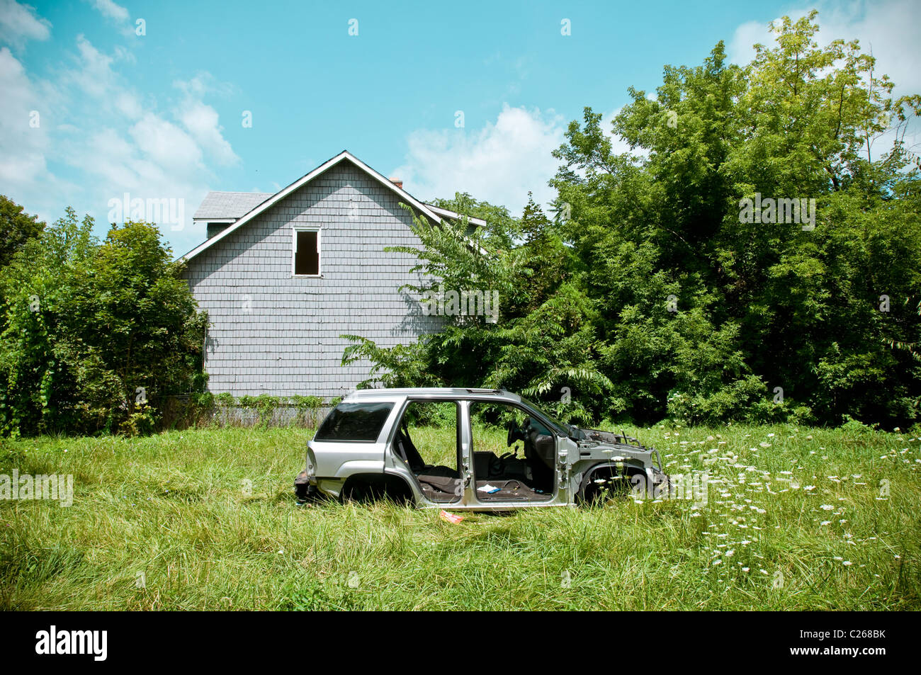 stripped out car in a vacant lot Stock Photo - Alamy
