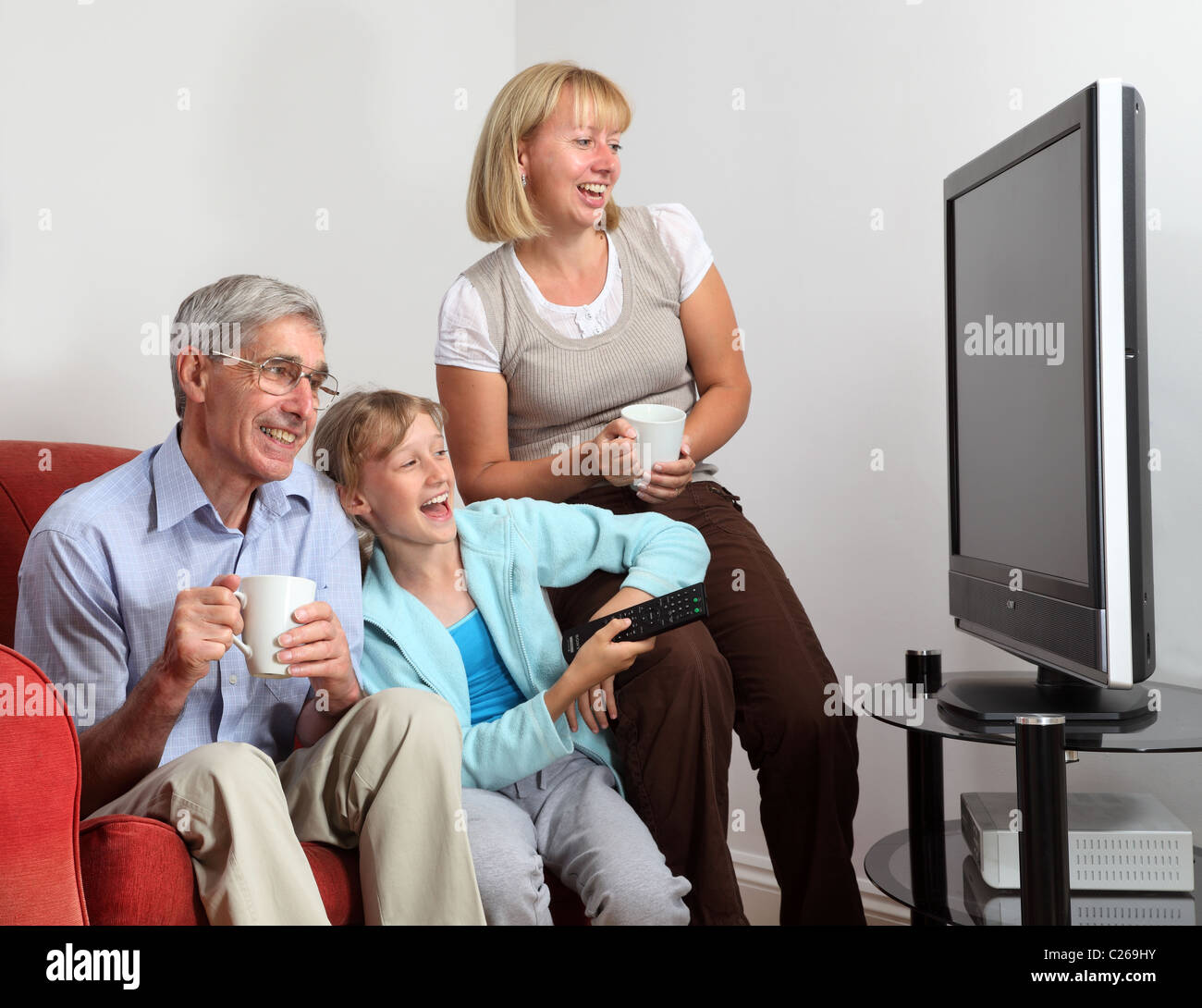 Three generations family watching tv hi-res stock photography and ...