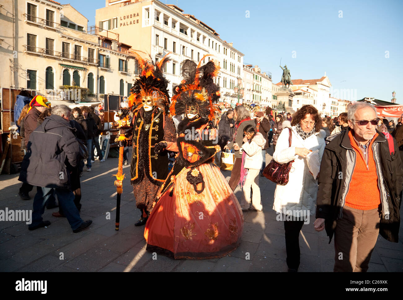 Masked characters mixing with the crowds on the waterfront at the ...