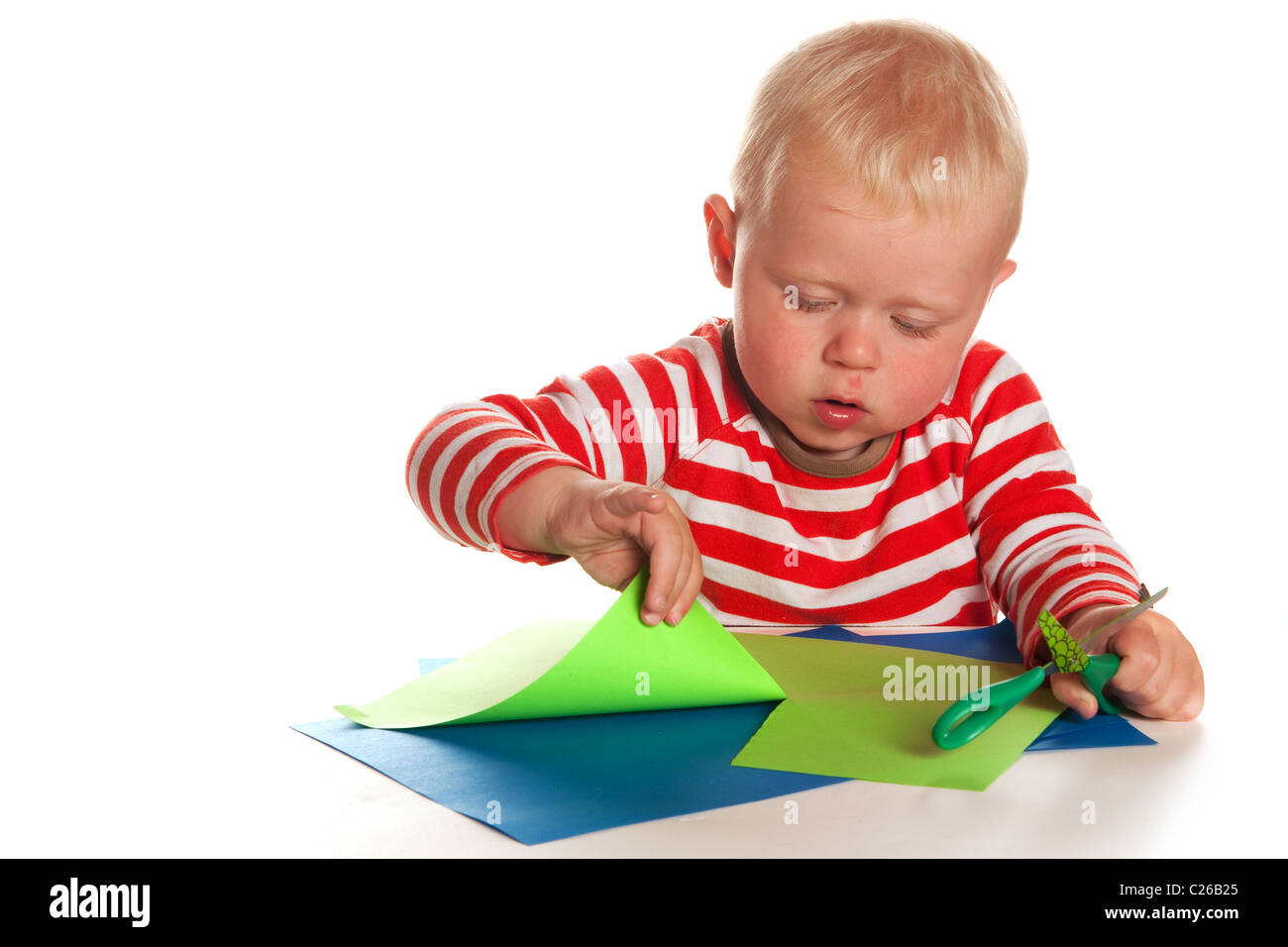 Little blond toddler boy is playing with scissors Stock Photo - Alamy