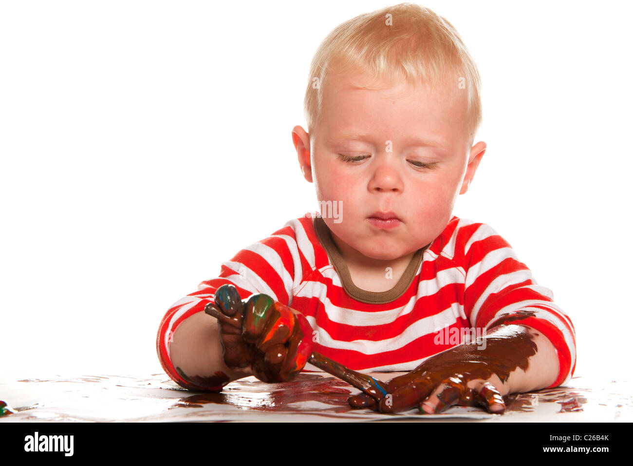 Little boy is painting and making a mess Stock Photo - Alamy