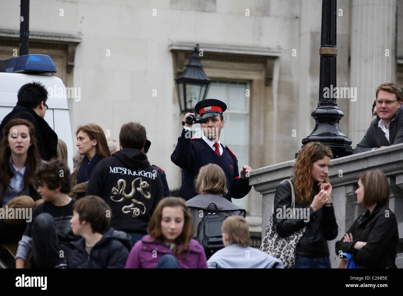 Security Guard films protesters in Trafalgar Square Stock Photo - Alamy