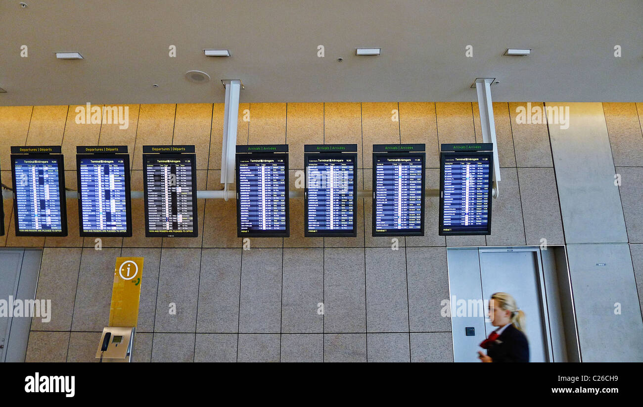 Arrival and departure screens in airport terminal Stock Photo - Alamy