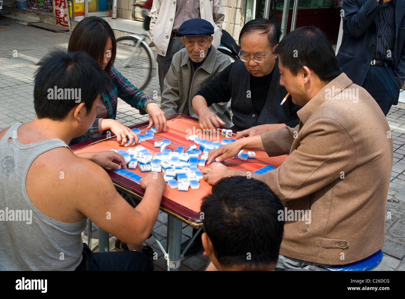 Chinese play Mahjong game open air on a market of Xining city Stock ...