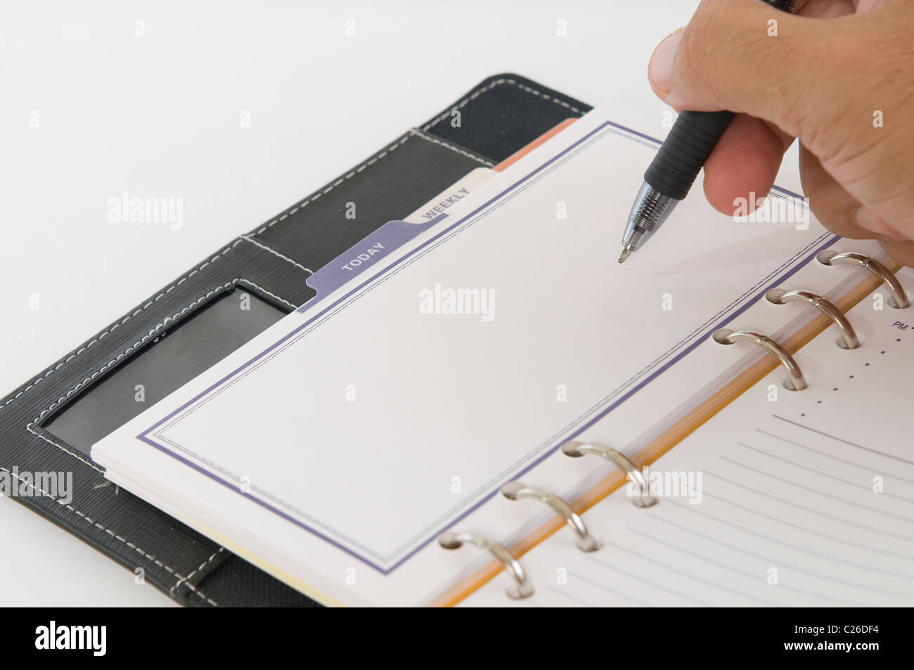 Hands holding a pen and blank page organizer Stock Photo - Alamy