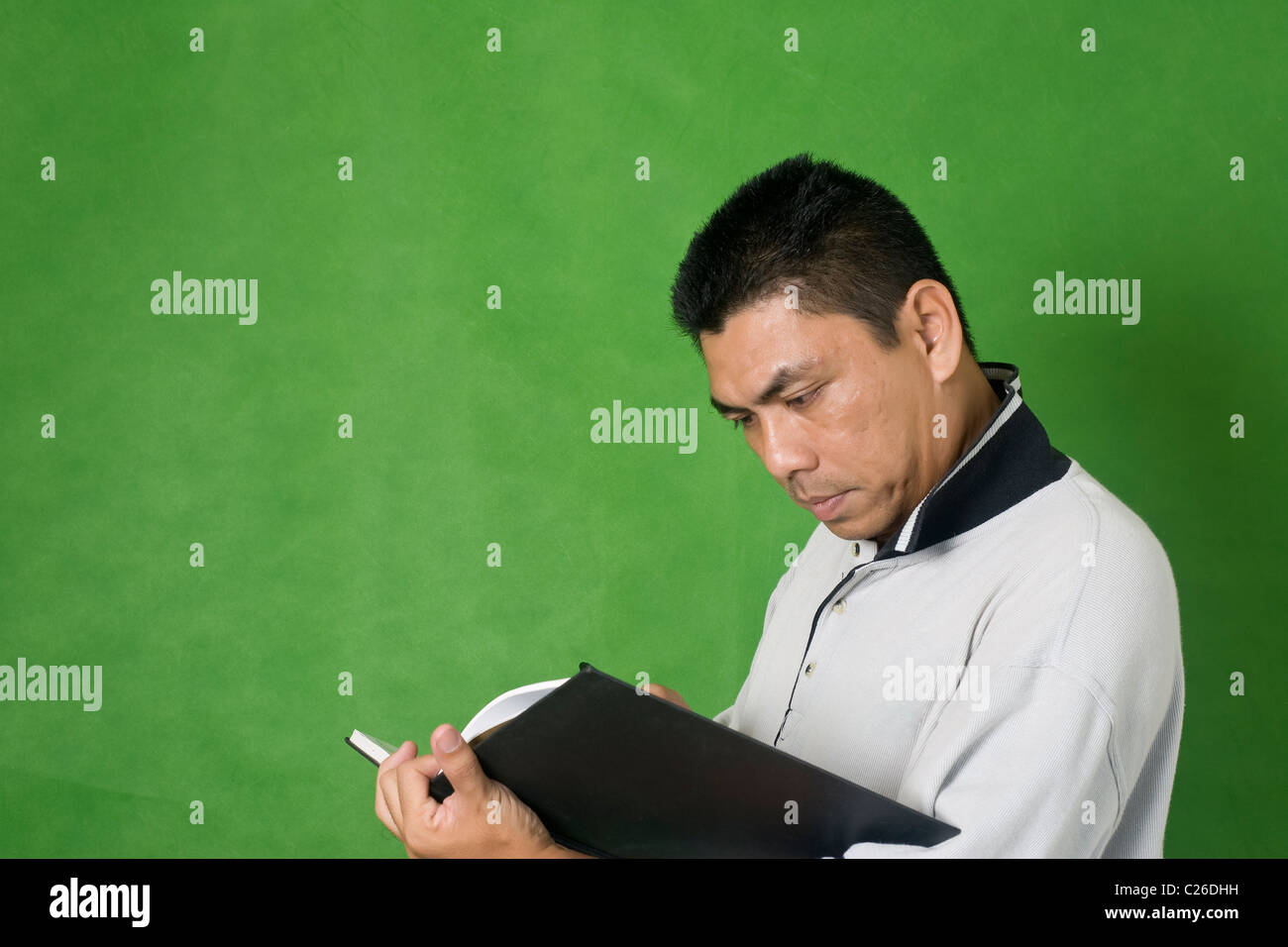 a man reading something on a book Stock Photo - Alamy