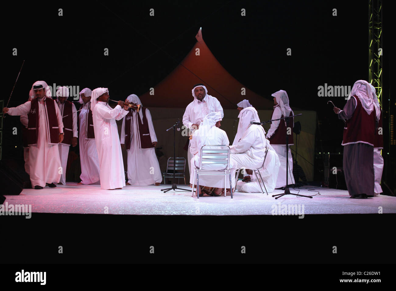 A Qatari cultural troop perform a traditional dance with camel sticks ...