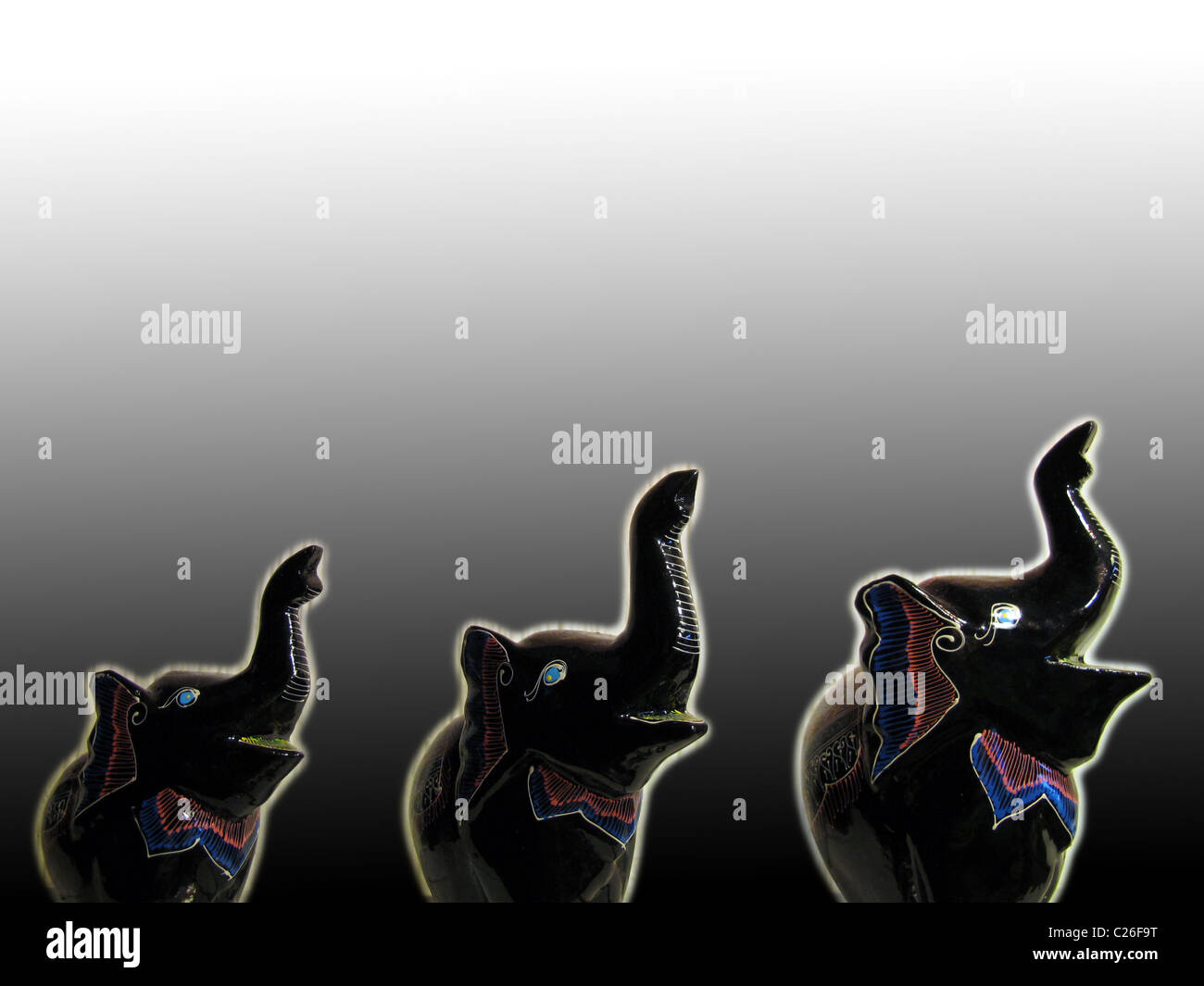 blacks elephants with bow on gray degraded Stock Photo - Alamy