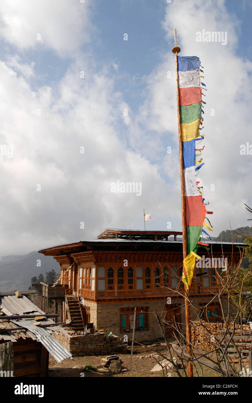 Farm house and prayer flag, Ura village, central Bhutan Stock Photo - Alamy