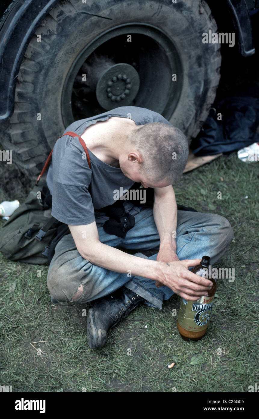 young person slouched over a bottle drunk on cider at an outdoor ...