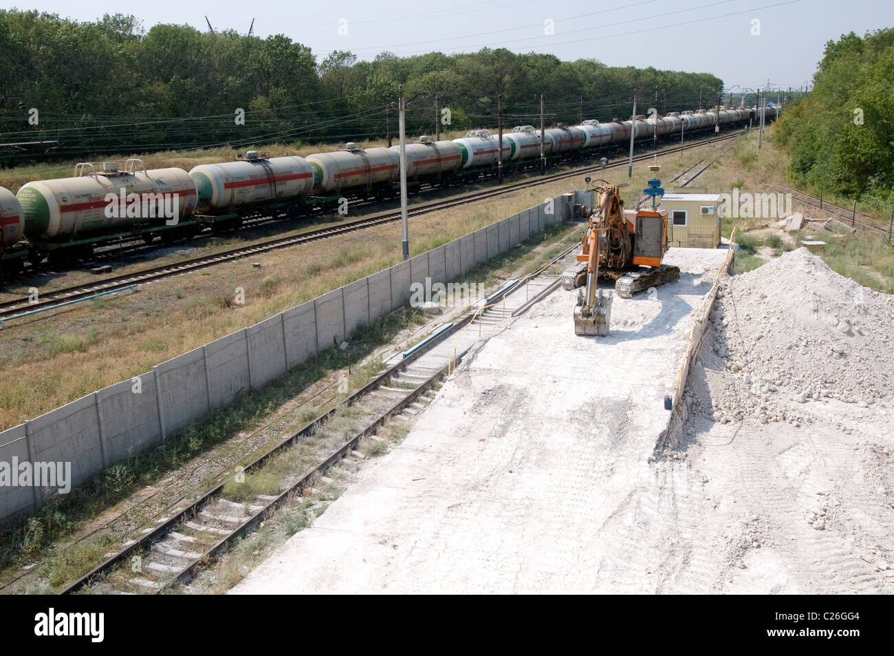 Industrial tractor rides along the embankment of industrial waste Stock ...