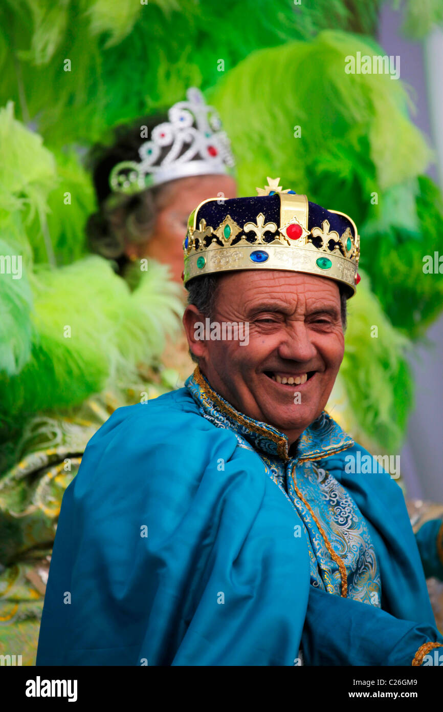 A man is dressed as the king of a Samba school and smiles at the Mardi ...