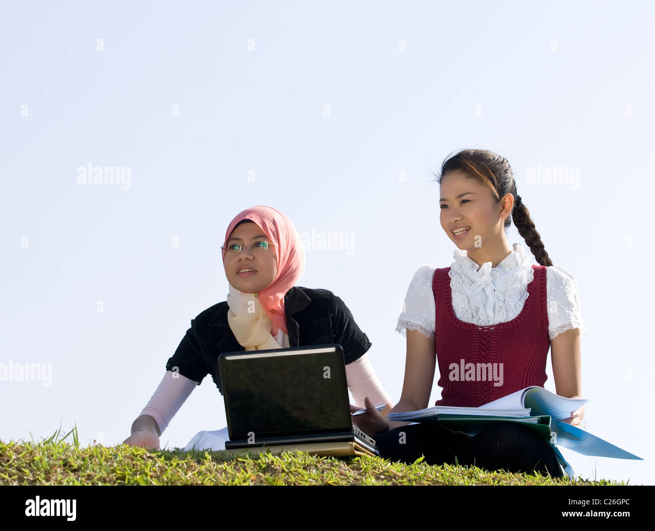 Two girls studying together in the field Stock Photo - Alamy
