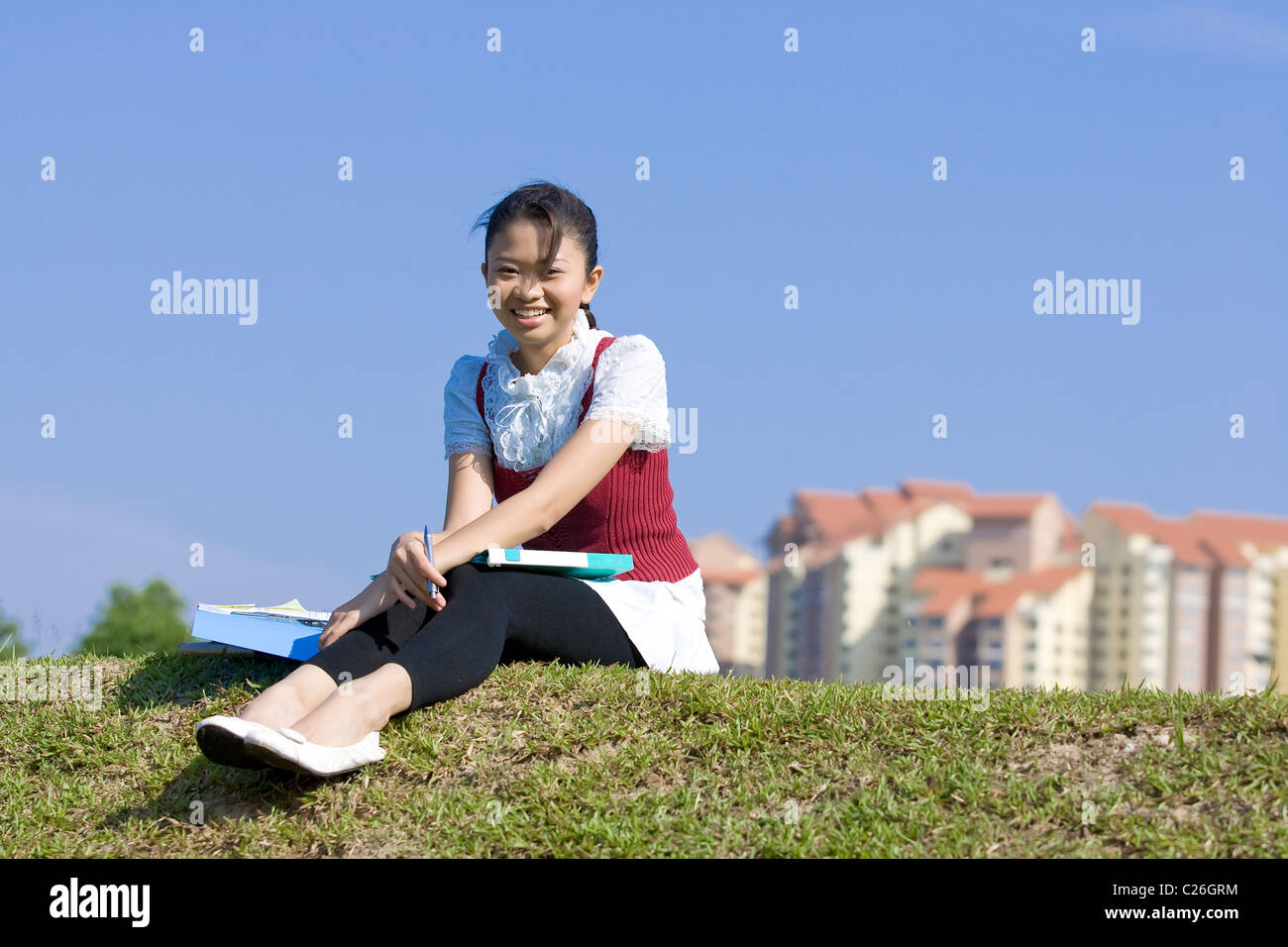 Young girl study alone at the park Stock Photo - Alamy