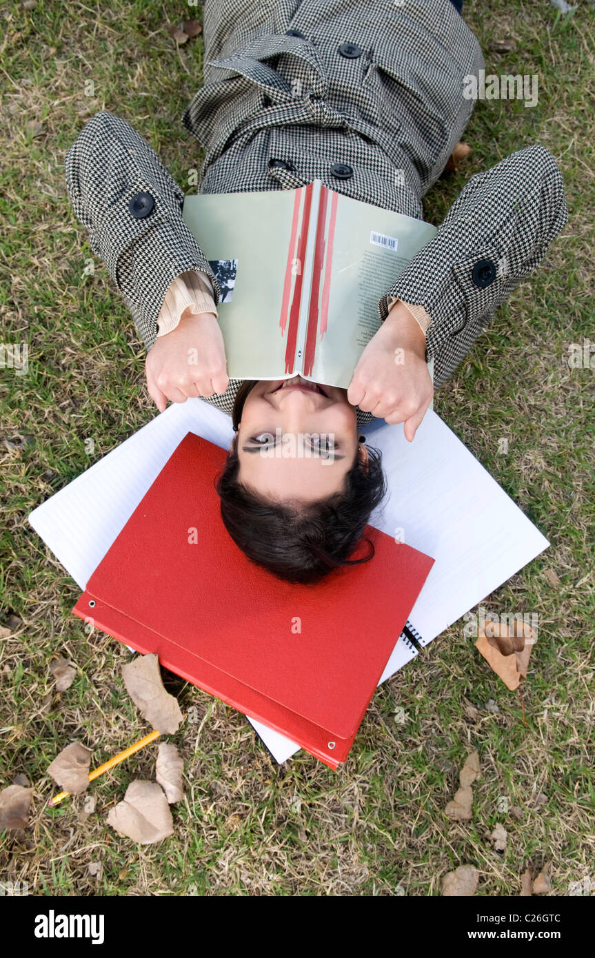 Lady, woman, body, lay, laying, down, hold, holding, a, book, red, on ...