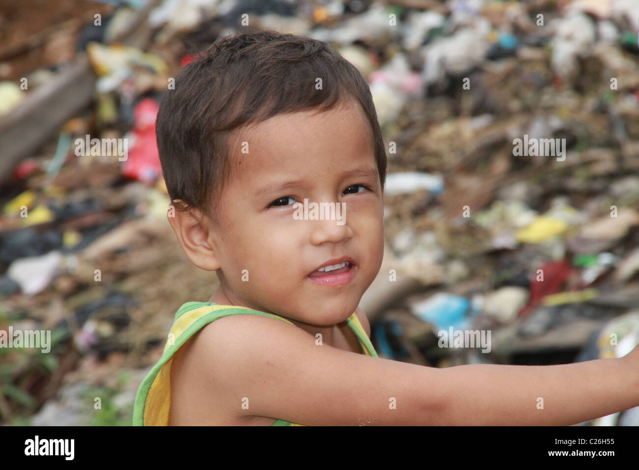 Peruvian boy playing in front of a garbage dumping site Stock Photo - Alamy