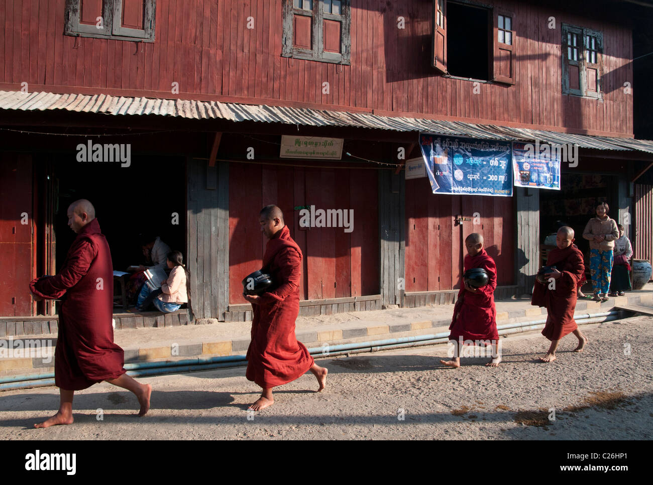 Monks gathering alms in the streets of Nahmsan town. Northern Shan ...