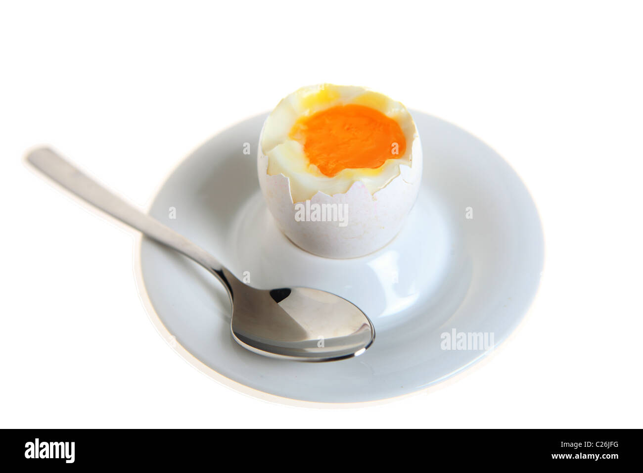 A boiled egg in a white eggcup, isolated, with a spoon Stock Photo - Alamy