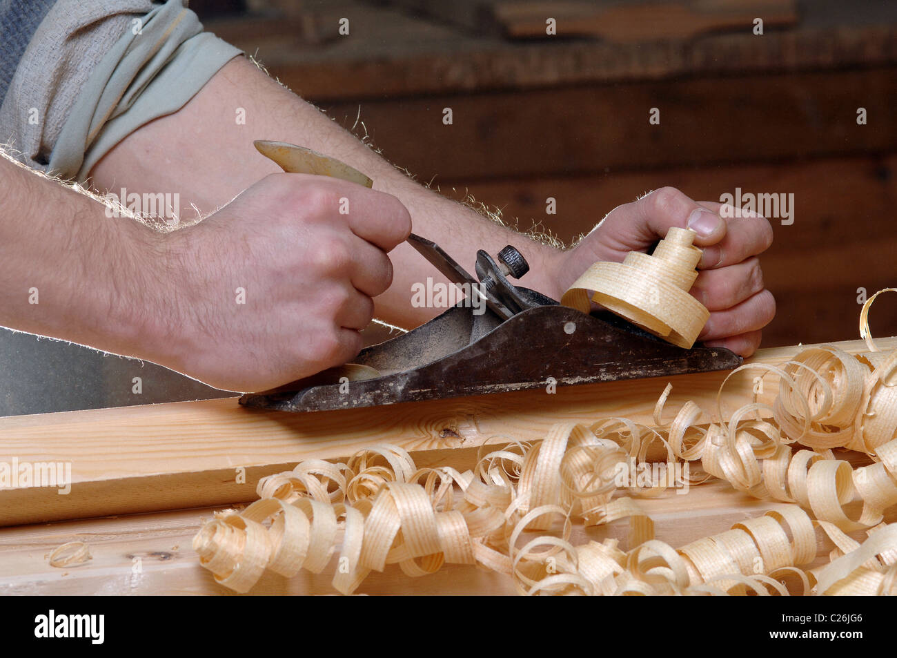 Hands of a carpenter planed wood, workplace Stock Photo - Alamy