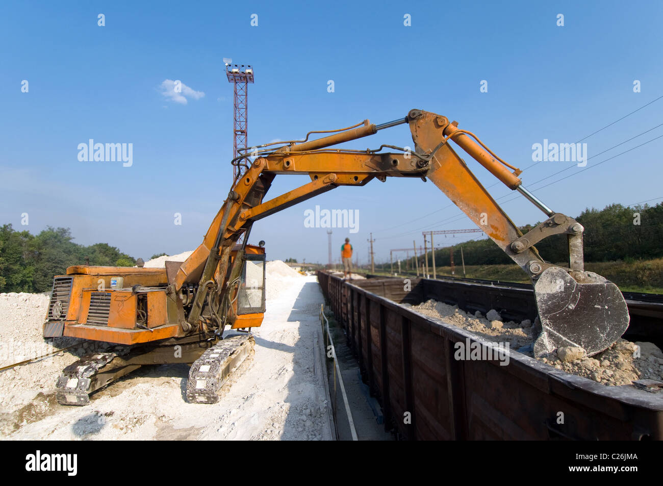 Loader loads the wagon train transport Stock Photo - Alamy