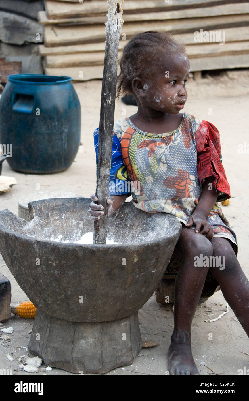 A young girl mashing cassava ,Betou,Ubangi River ,Republic of Congo ...