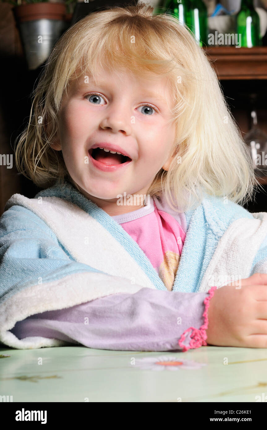 Stock photo of a portrait of a young child sitting at a table Stock ...