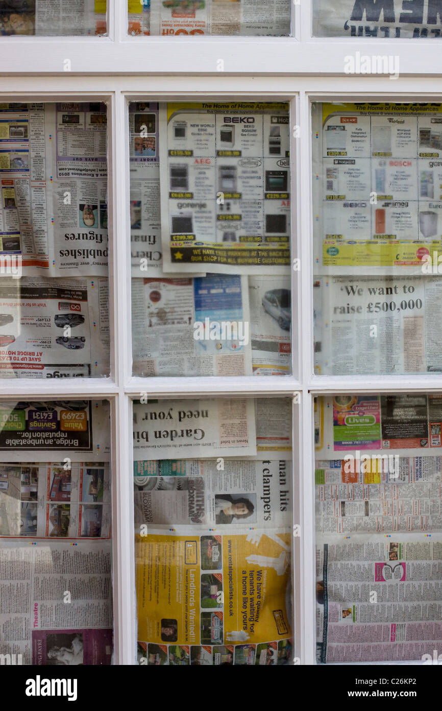 Closed Down Shop with Windows covered in Newspaper Stock Photo - Alamy