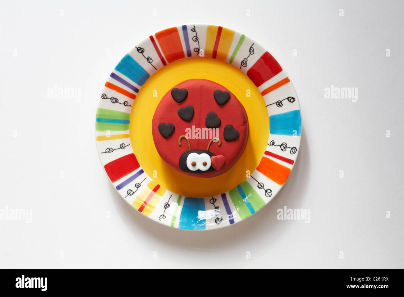 marzipan cake in shape of a ladybird lady bird placed on colourful ...