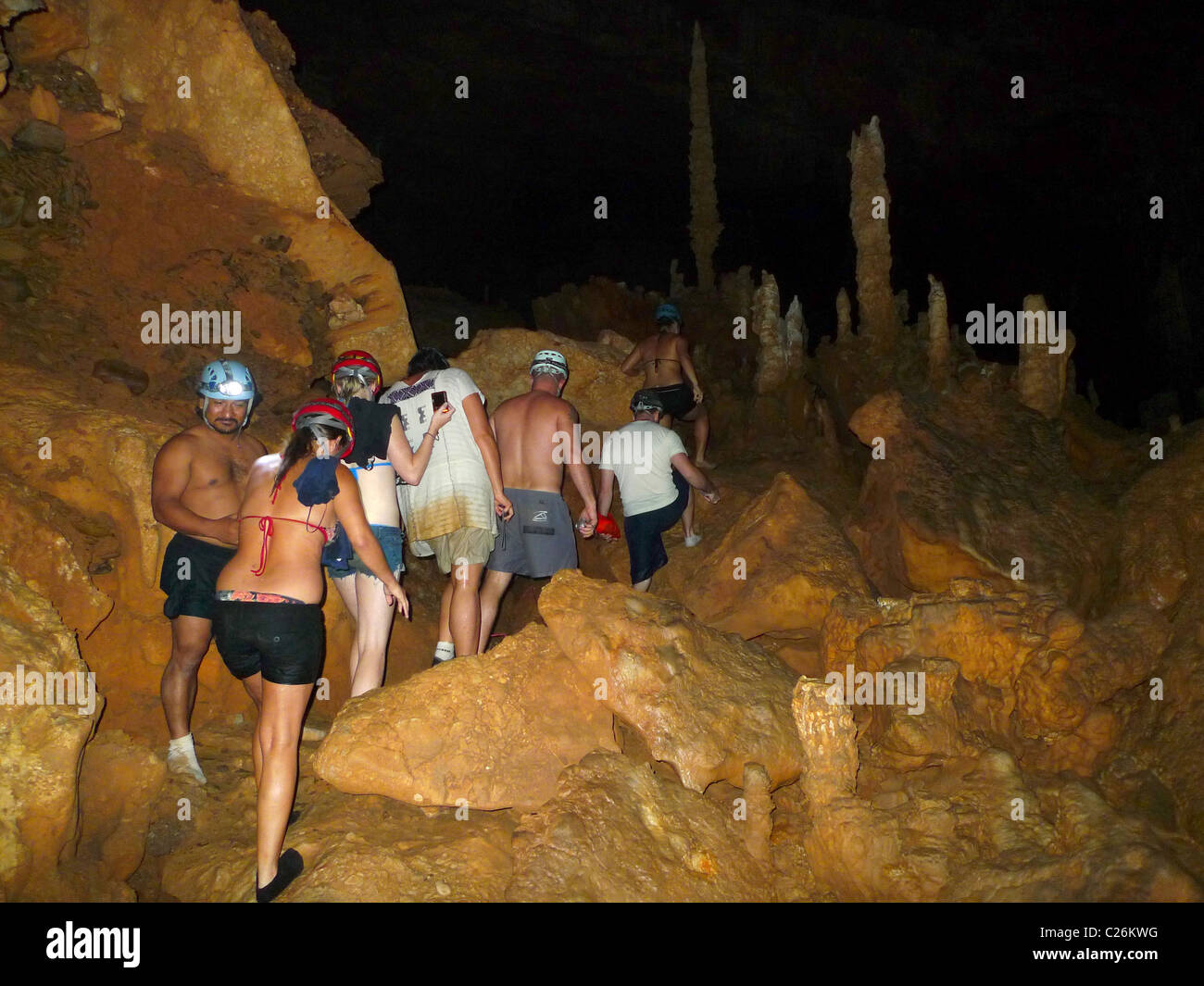 Tourists being led through ATM Actun Tunichil Muknal cave in Belize ...