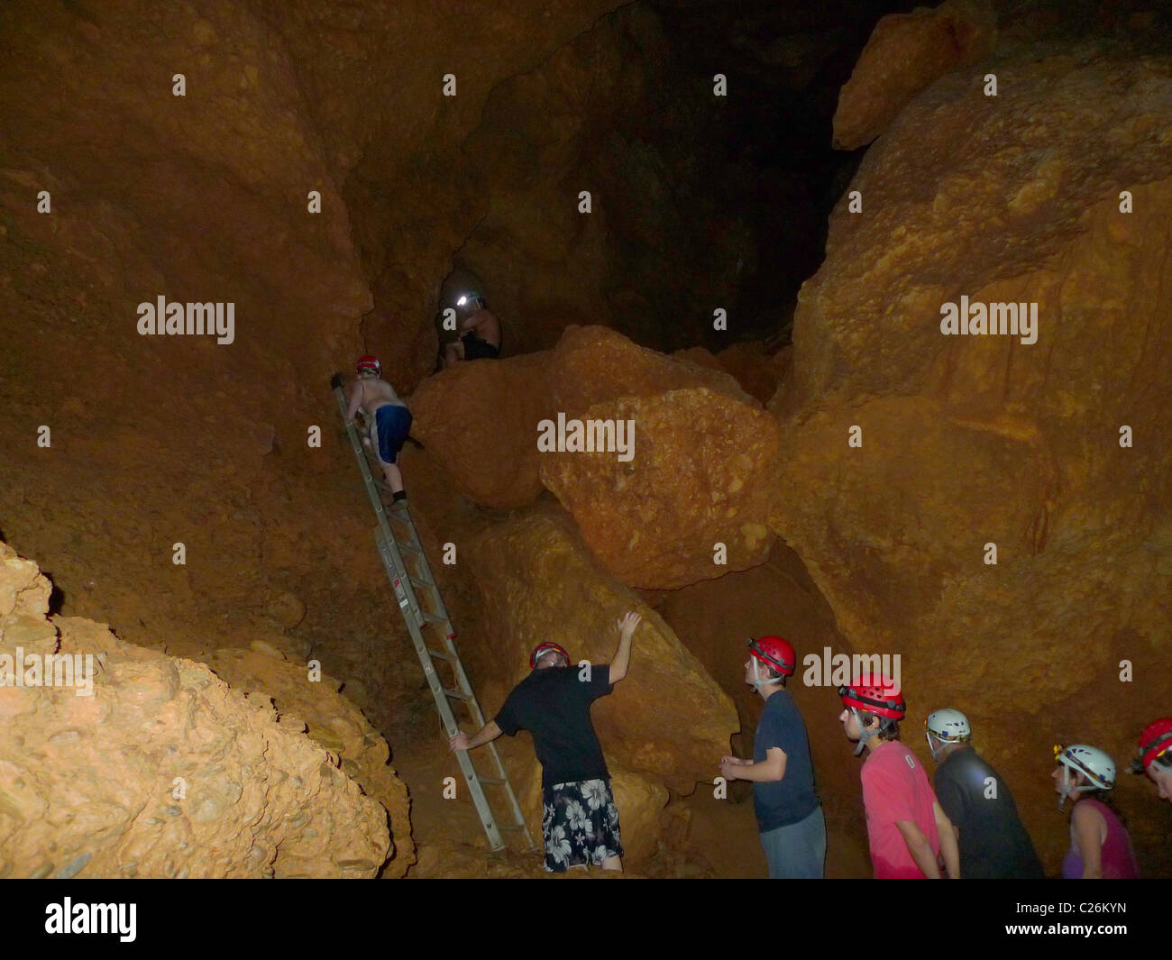 Tourists being led through ATM Actun Tunichil Muknal cave in Belize ...