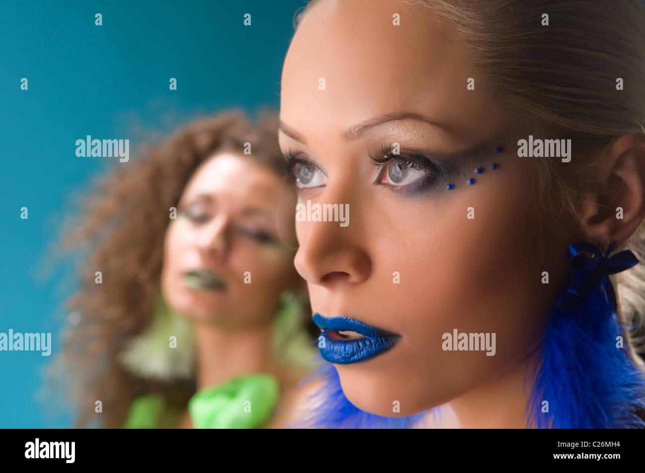 Two women in studio on blue background Stock Photo - Alamy