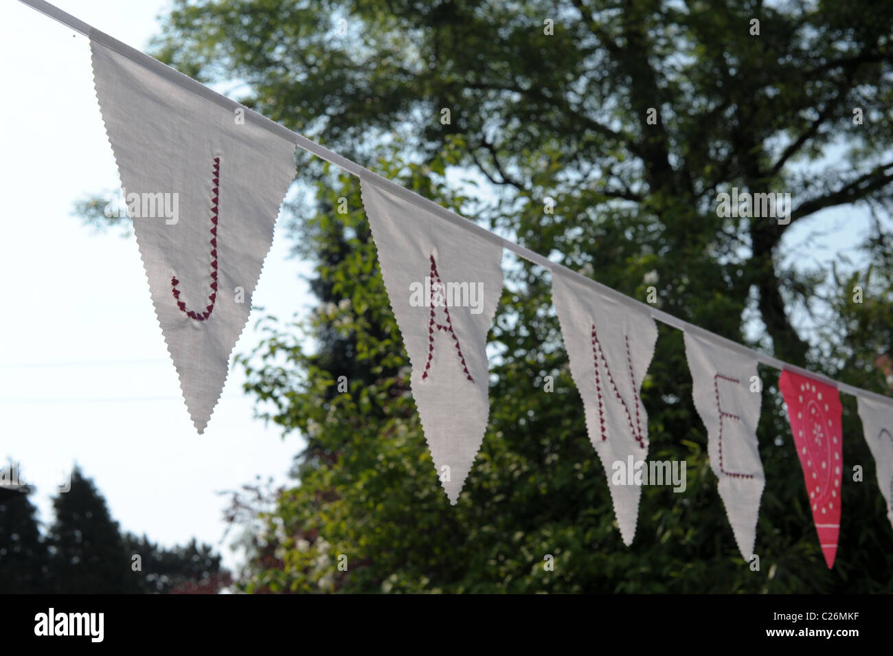 Homemade pink and white bunting with spelling out the name Jane at an ...
