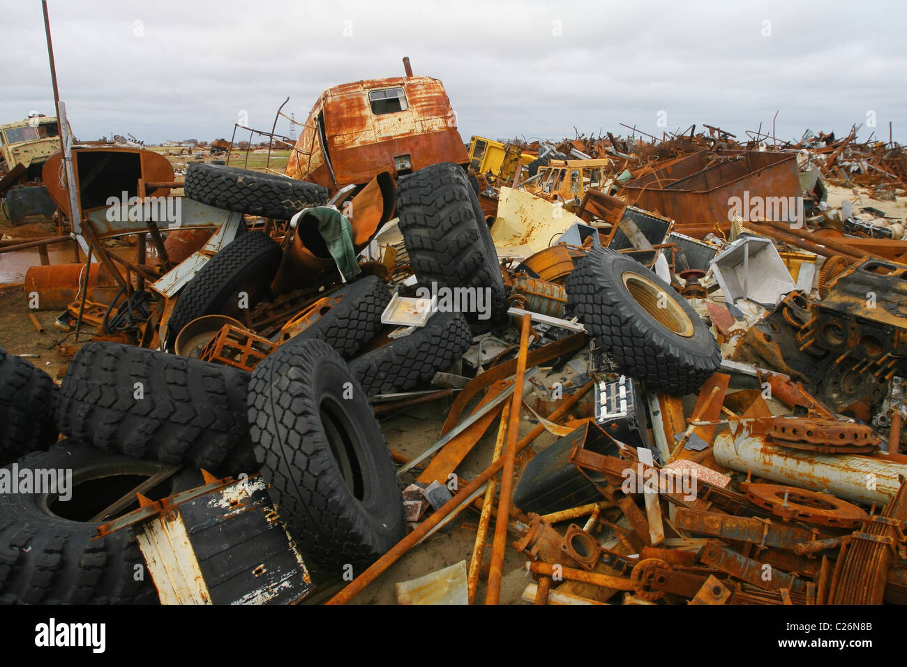 Rusty metal, heavy tires and so on occupy the frame space to the ...