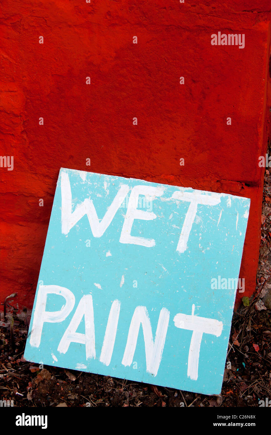 Wet paint sign with wall painted red behind Portmeirion Wales UK Stock ...
