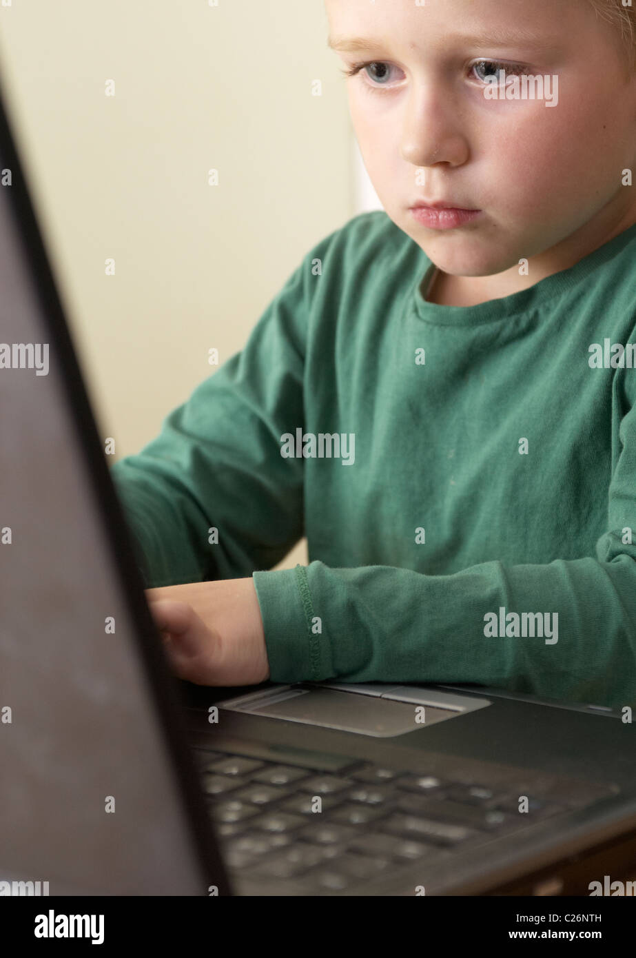 Child blond boy playing with notebook - computer Stock Photo - Alamy